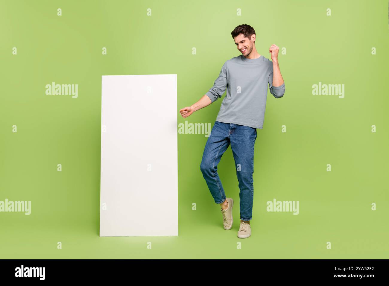 Full size photo of cheerful handsome guy have fun dancing promote phone ...