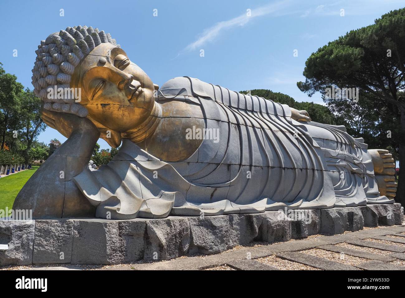 Large granite Buddha or lying Buda, in the blue sky background, in the ...