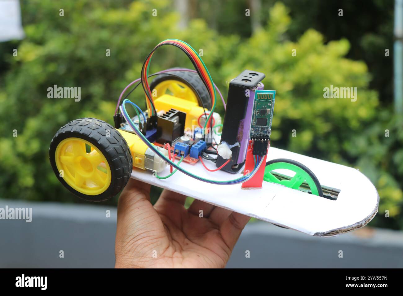 Bluetooth controlled robot car held in the hand on a natural background ...