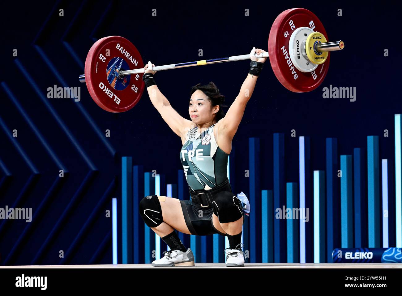 Cheng-Jing Lin of Chinese Taipei competes in snatch, in the 49 kg women ...