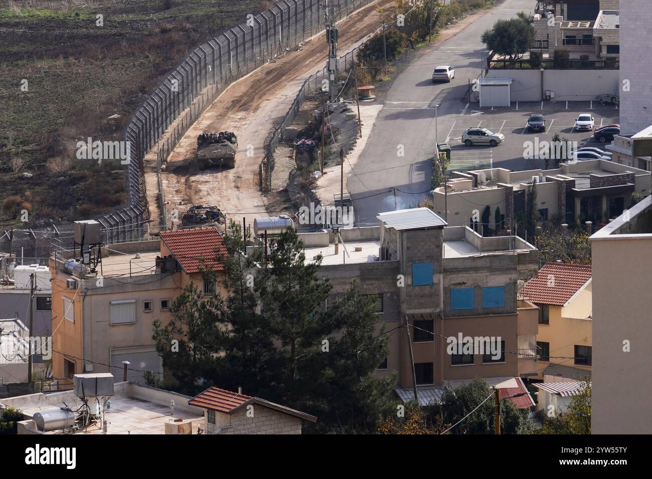 An Israeli army tank maneuvers near the so-called Alpha Line that ...