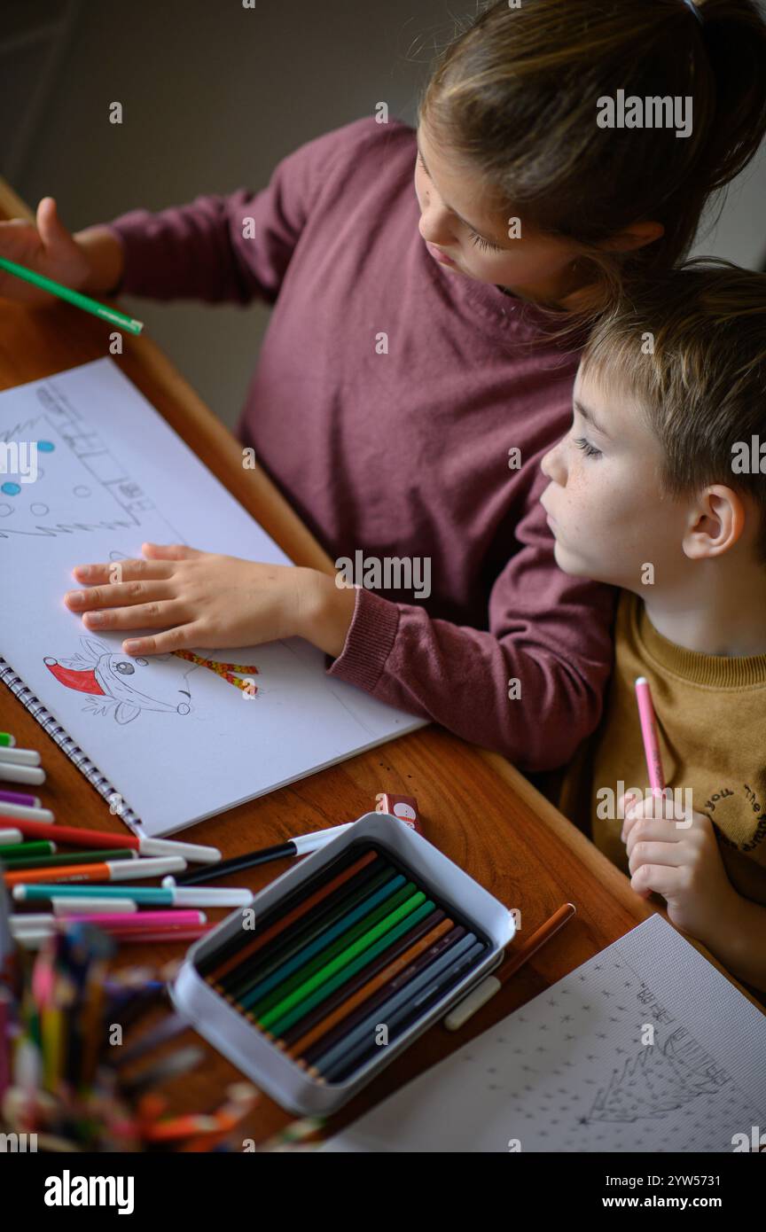 boy and girl are studying and drawing together Stock Photo - Alamy