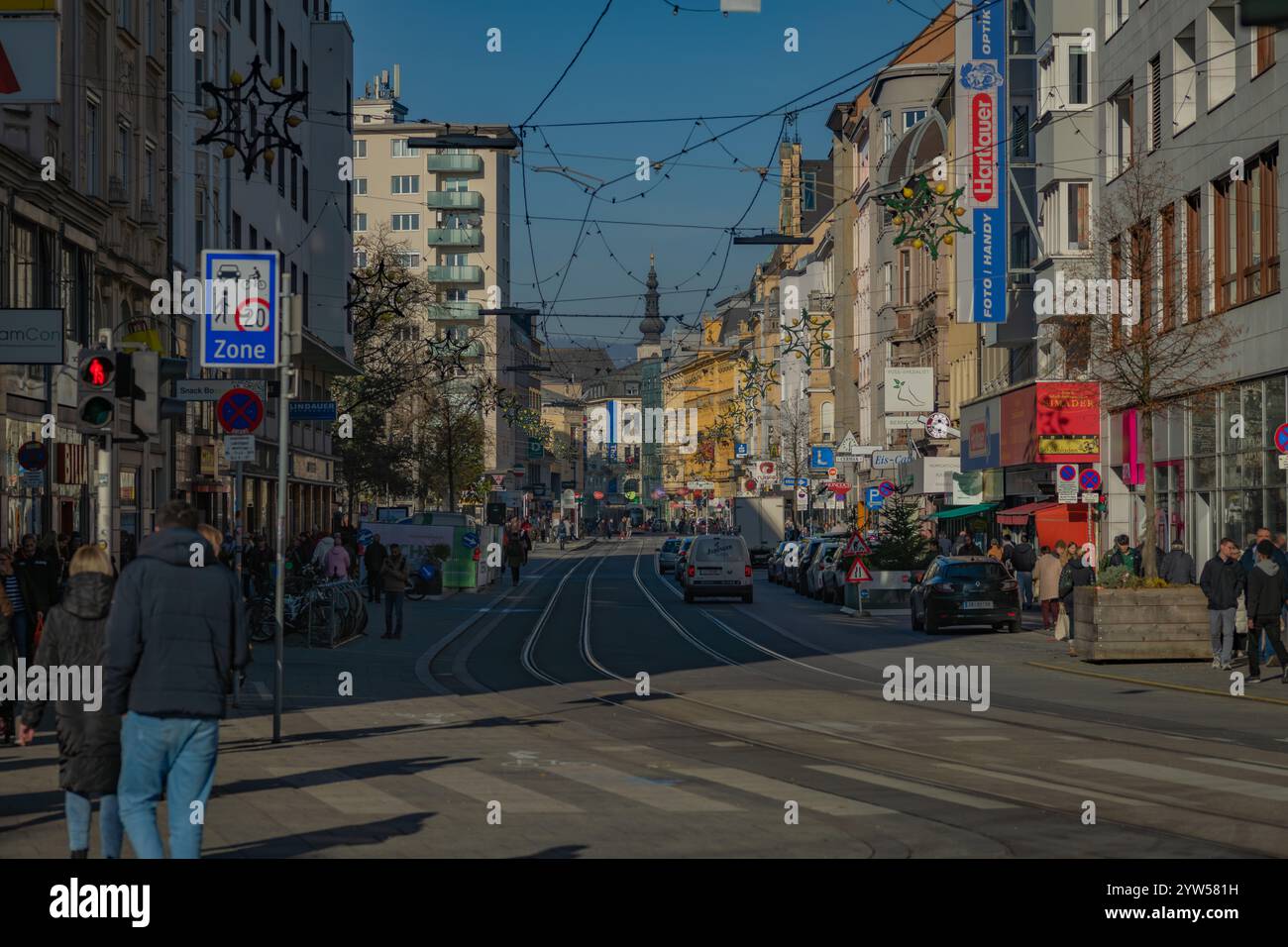 Sunny color autumn streets with public transport and people in Linz ...