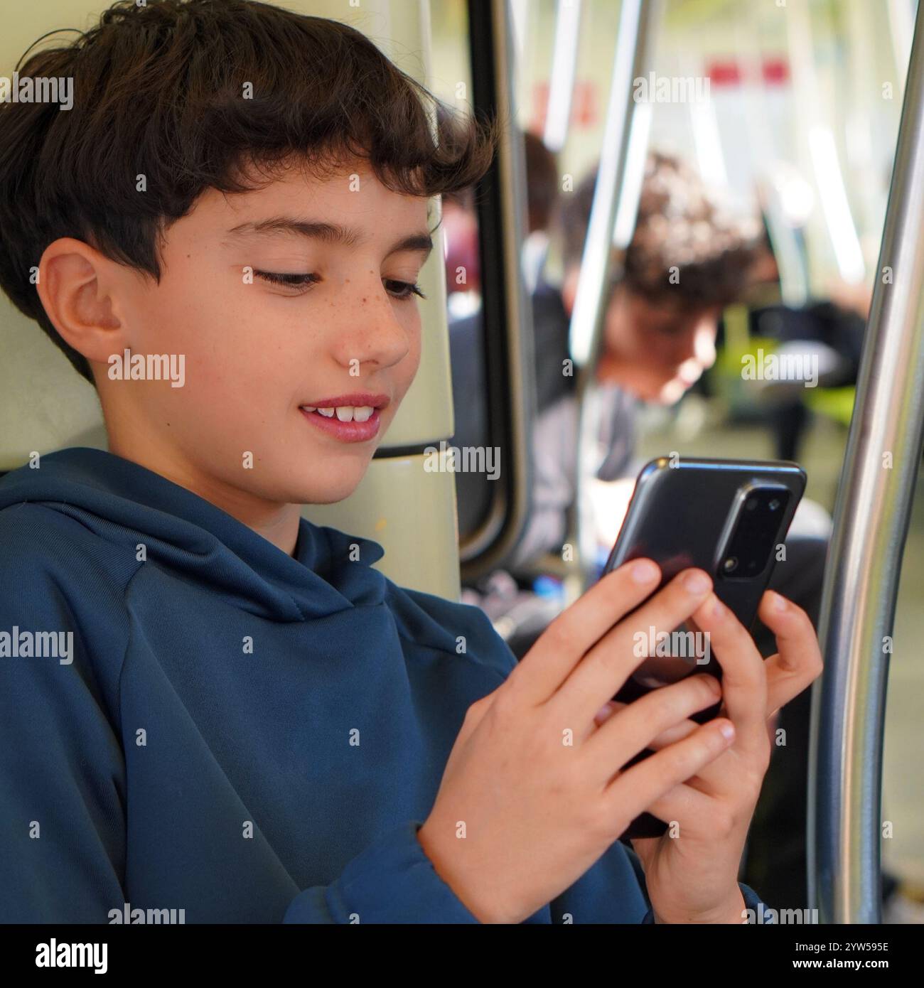teenage boy traveling by bus or subway using smartphone Stock Photo - Alamy