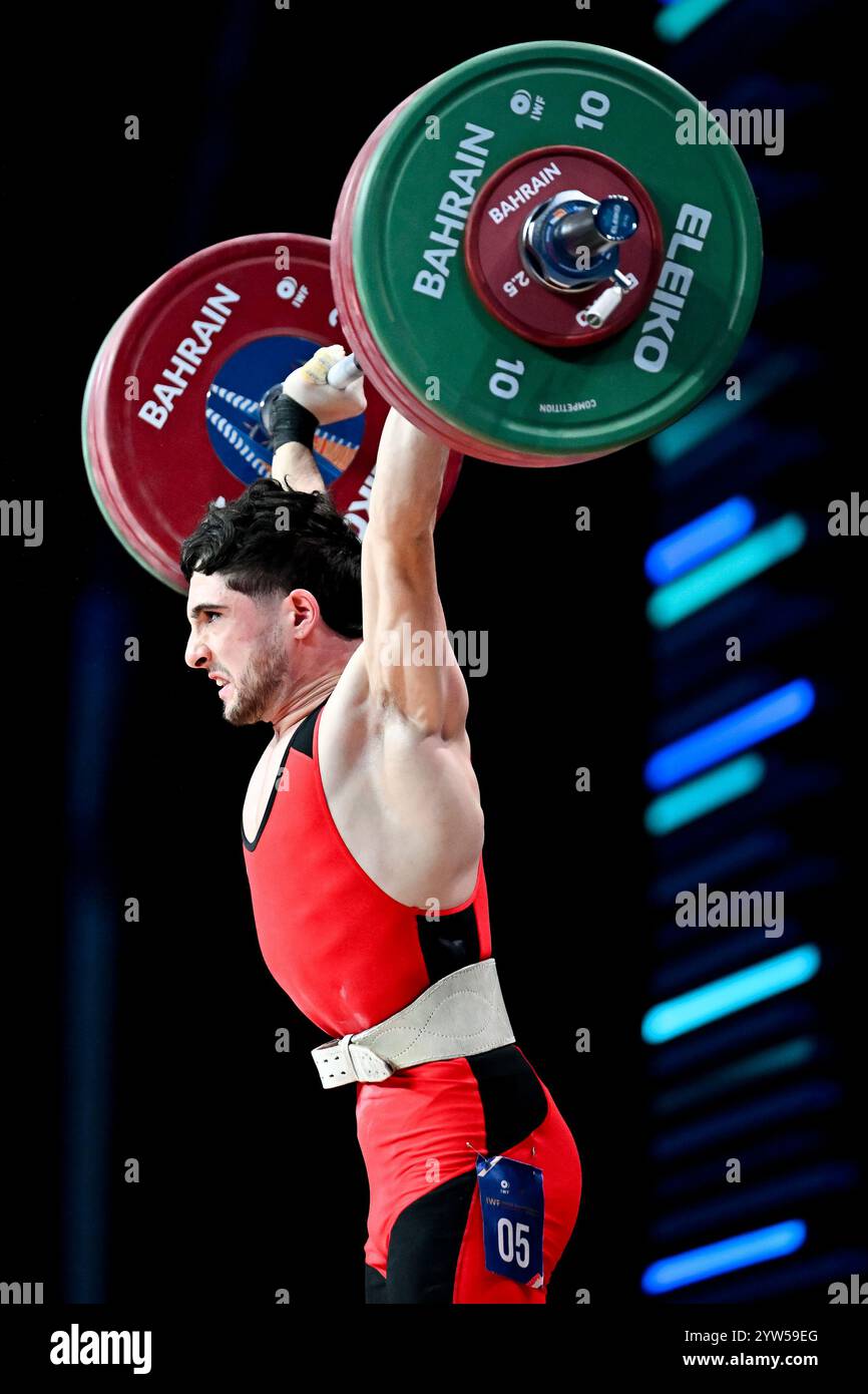 Garnik Cholakyan of Armenia competes in clean & jerk, in the 61 kg men ...