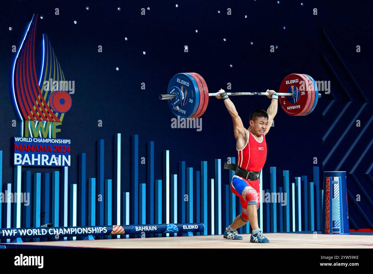 Myong Jin Pak of North Korea competes in clean & jerk, in the 61 kg men ...
