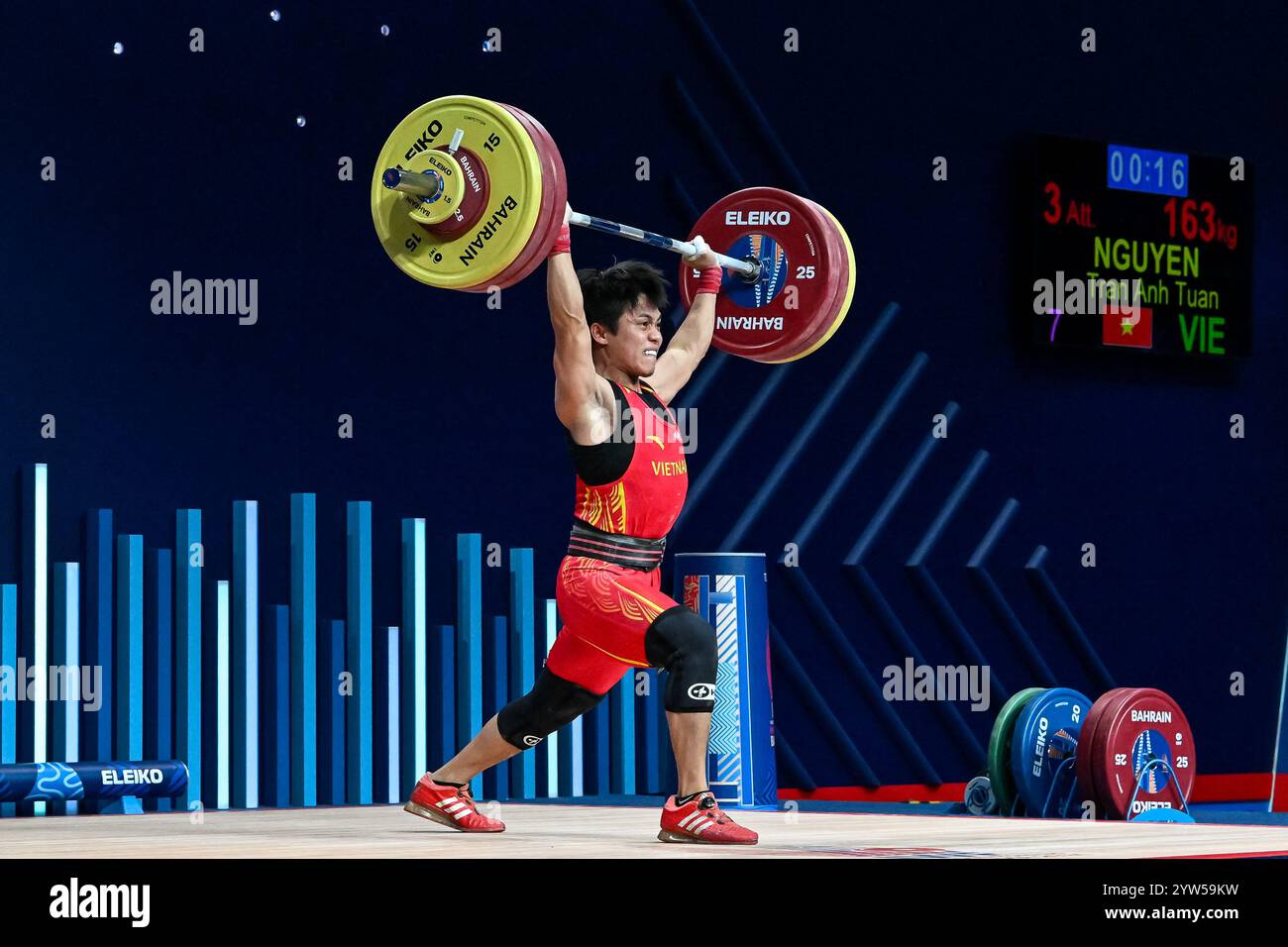 Tran Anh Tuan Nuyen of Vietnam competes in clean & jerk, in the 61 kg ...