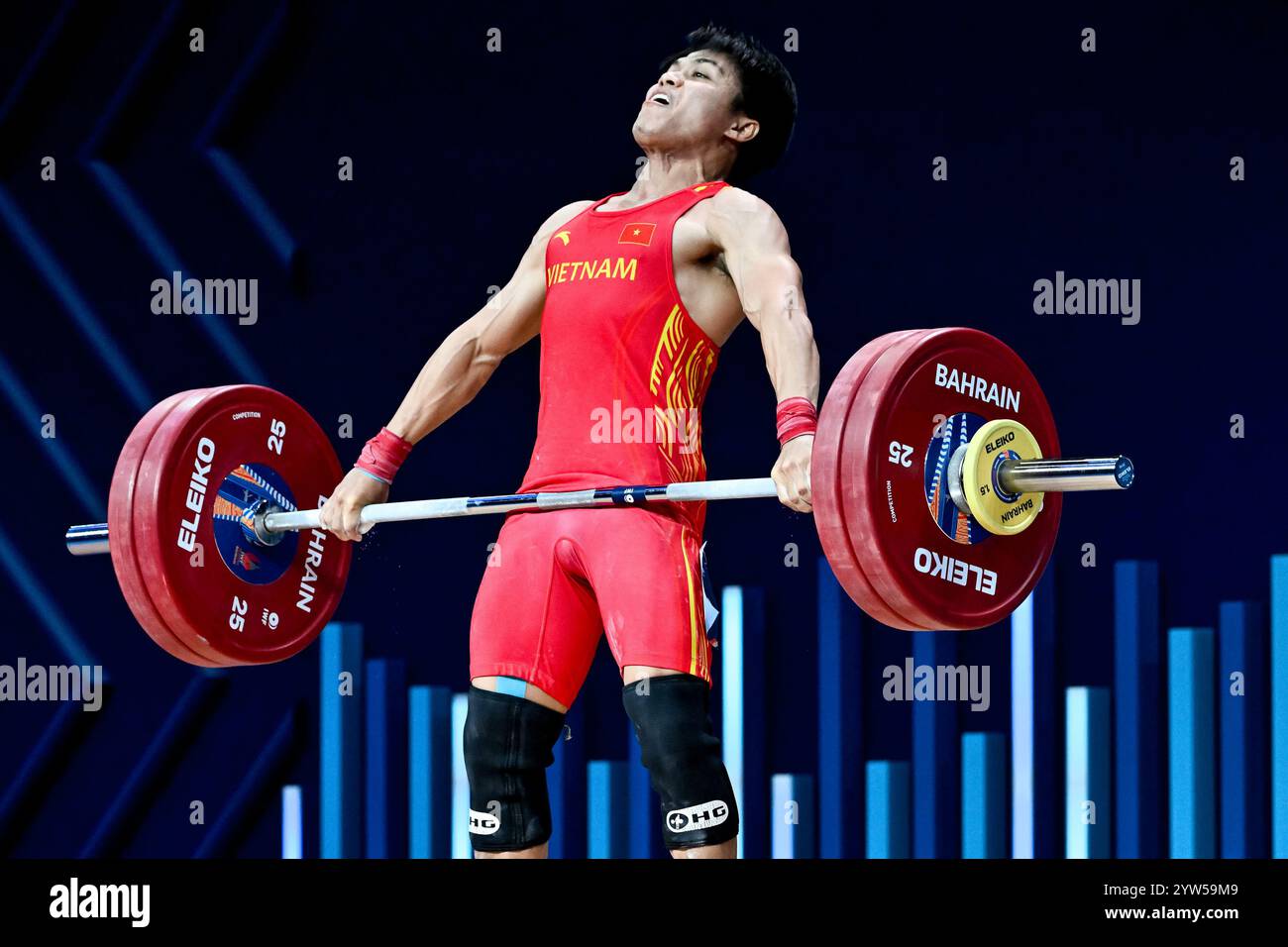 Tran Anh Tuan Nuyen of Vietnam competes in snatch, in the 61 kg men ...