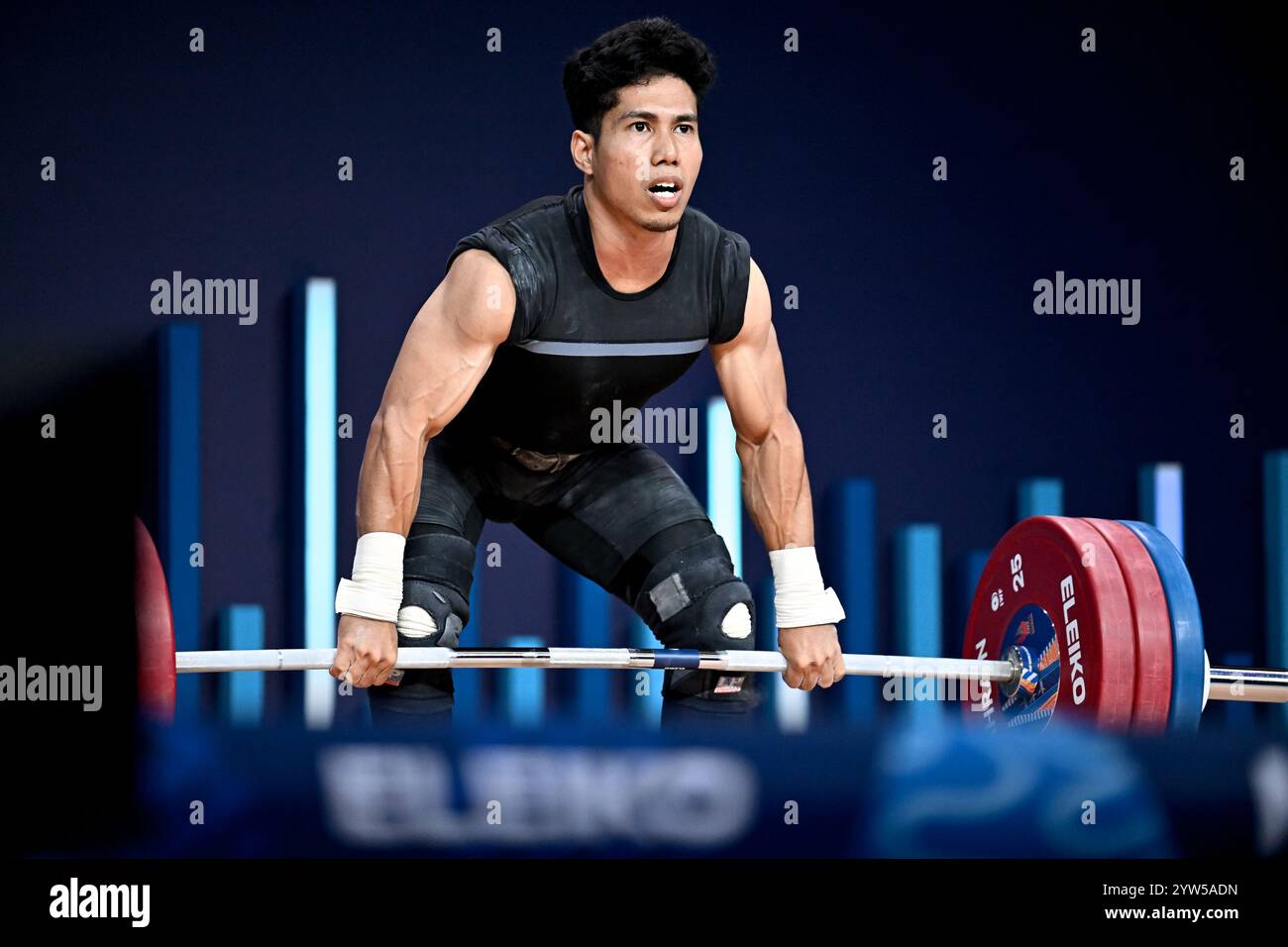 Aznil Bin Bidin Muhamad of Malaysia competes in clean & jerk, in the 67 ...