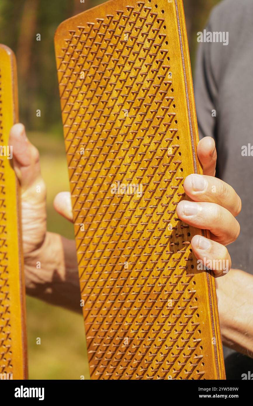 Two sadhu boards with nails. Close-up of a man holding two Sadhu boards ...