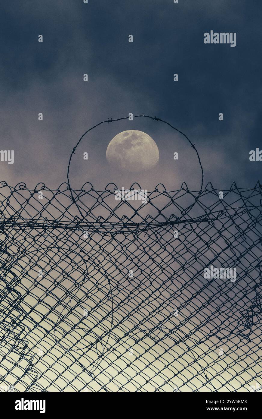 Full moon behind barbed wire fence Stock Photo - Alamy