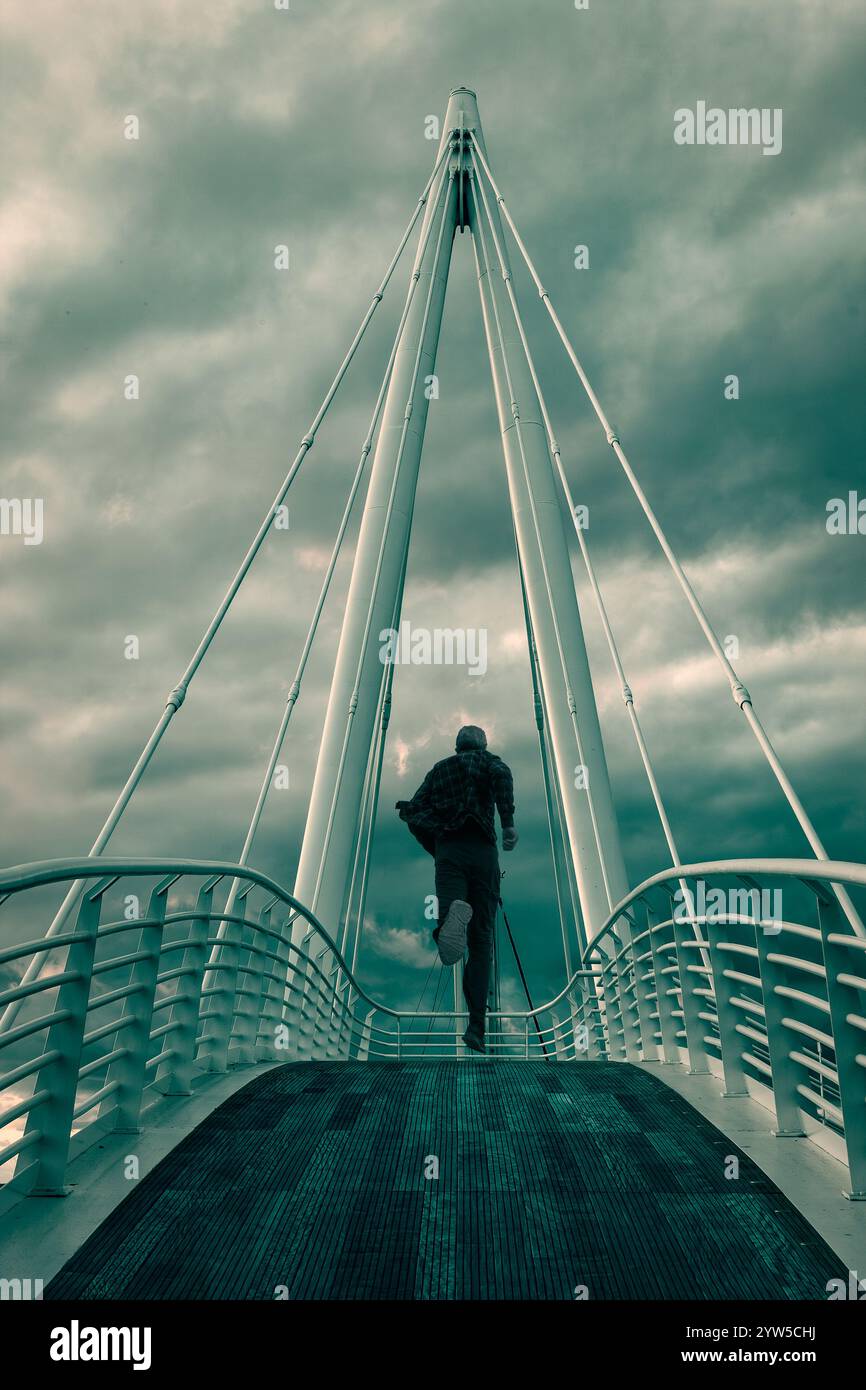 Rear view of man running over bridge hi-res stock photography and ...