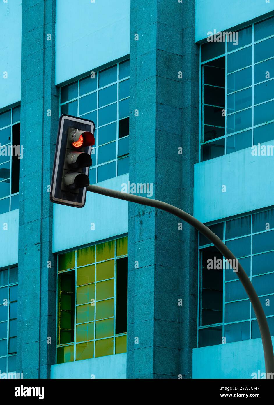 Red traffic light outside derelict building Stock Photo - Alamy