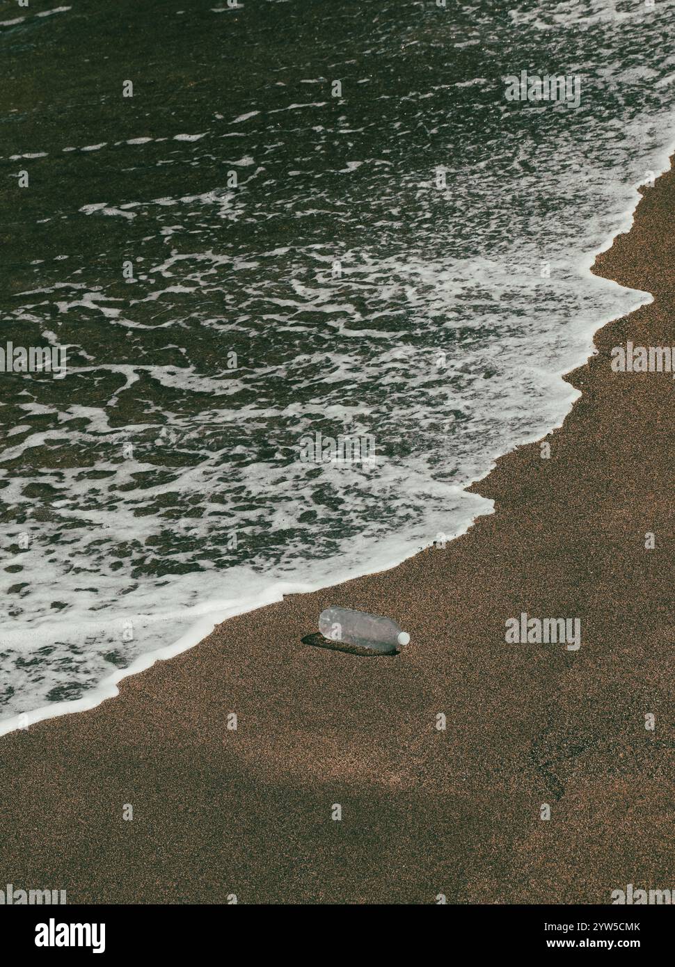 Plastic bottle on beach Stock Photo - Alamy