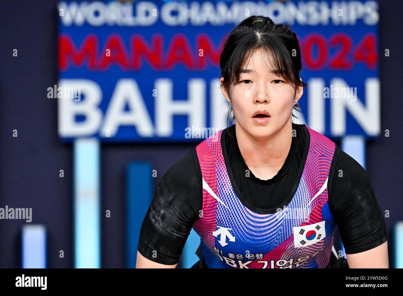 Gayoung Kim of South Korea competes in clean & jerk, in the 55 kg women ...