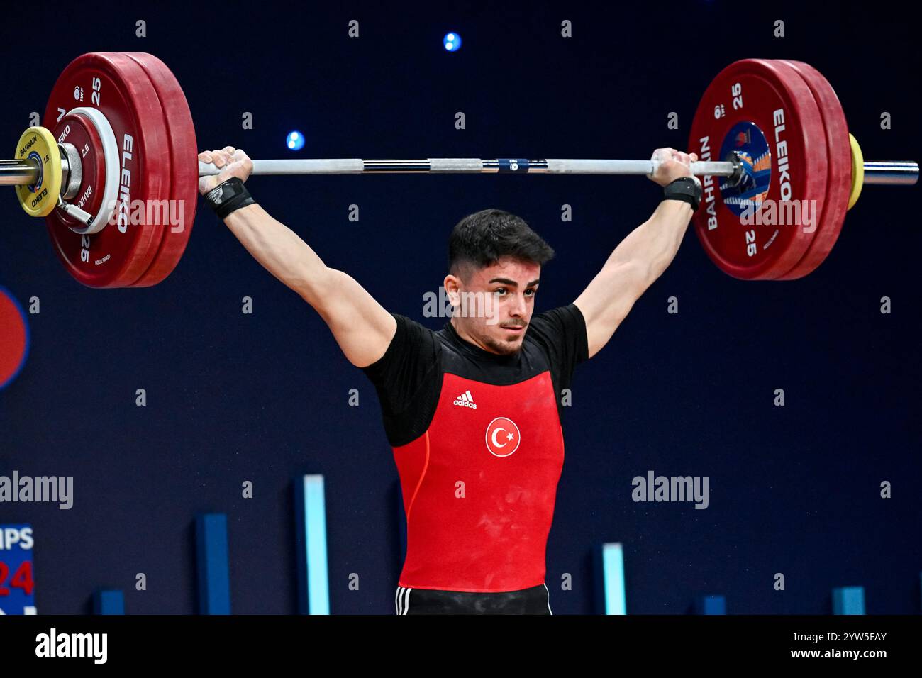 Kaan Kahriman of Turkey competes in snatch, in the 67 kg men category ...