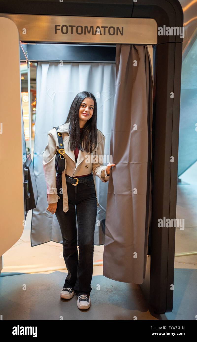 Stylish woman entering a modern photo booth, getting ready for a fun ...