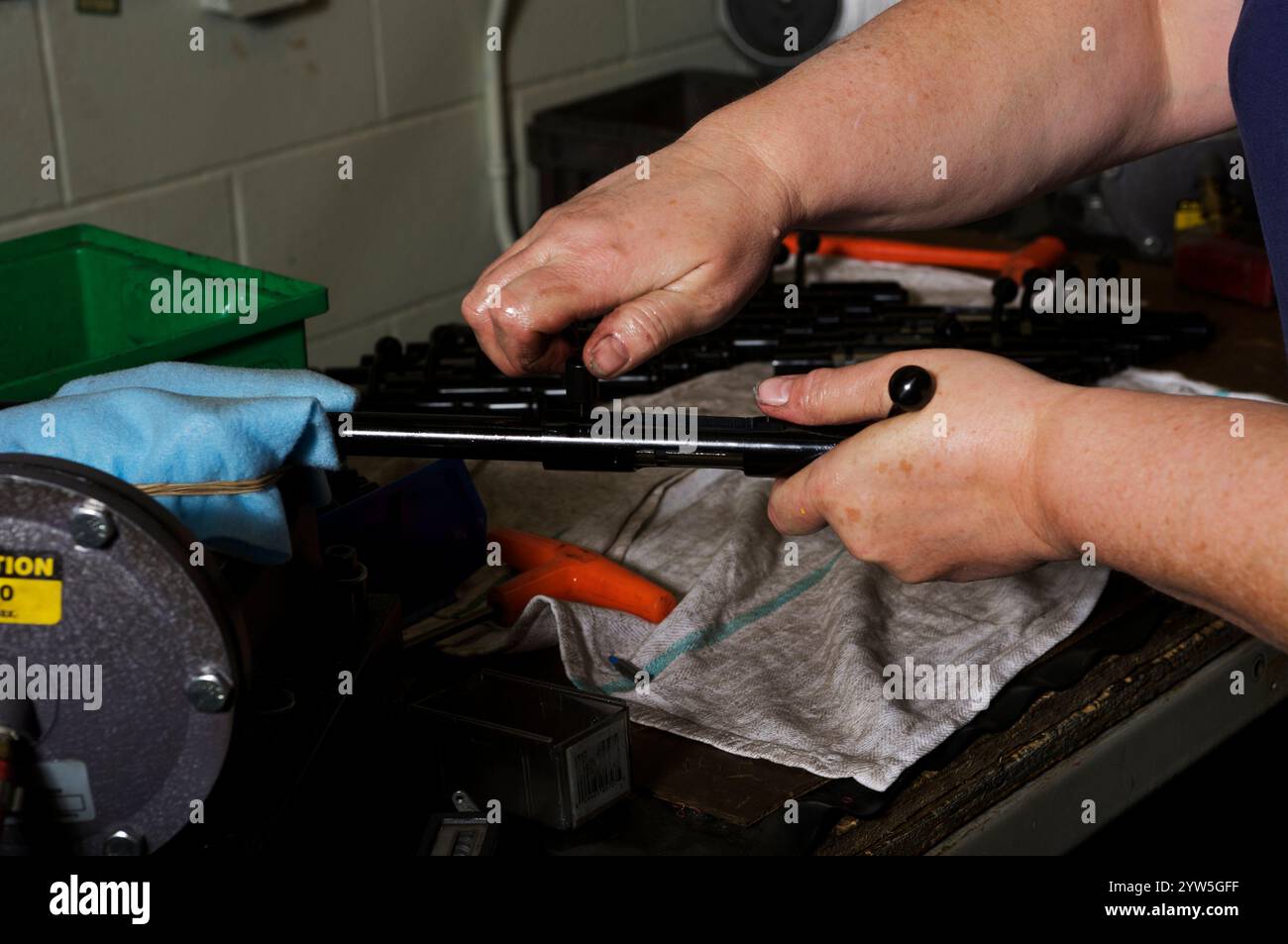 Workers in a local gun factory doing manual labour with their hands ...