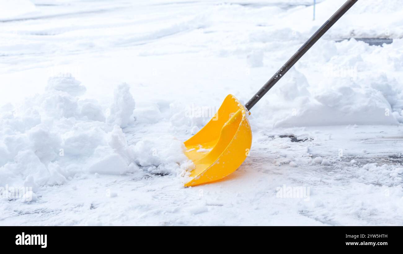 Man shoveling snow off of his driveway after a winter storm in Canada ...