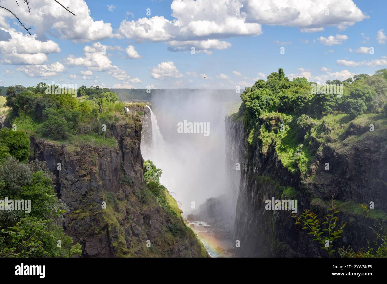 The iconic Victoria Falls, aka Mosi-Oa-Tunya waterfall, obscured by mist. View from Zimbabwe ...