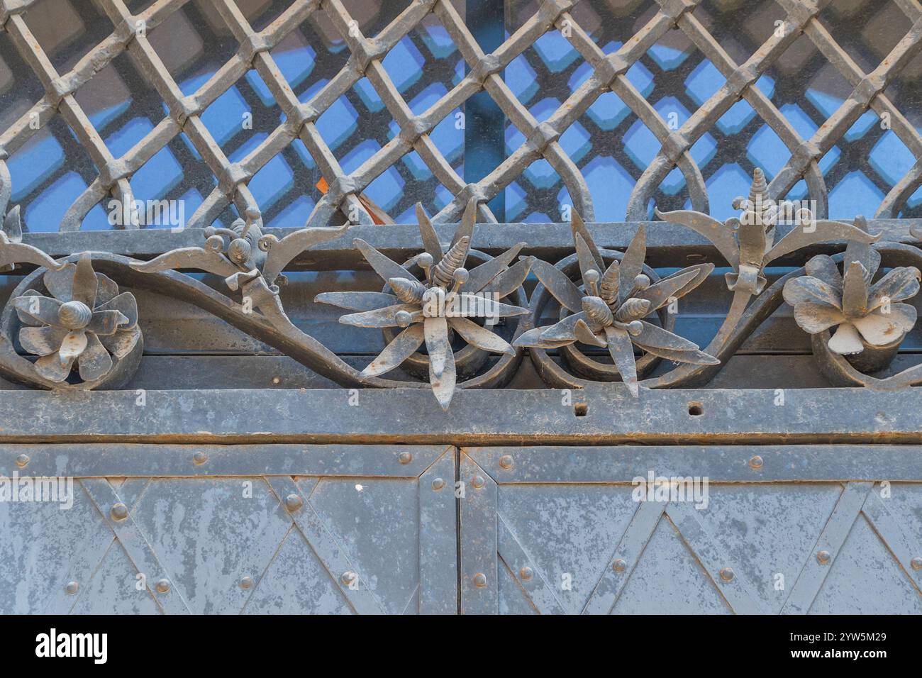 Ornate wrought iron gate with floral details, diamond patterns ...