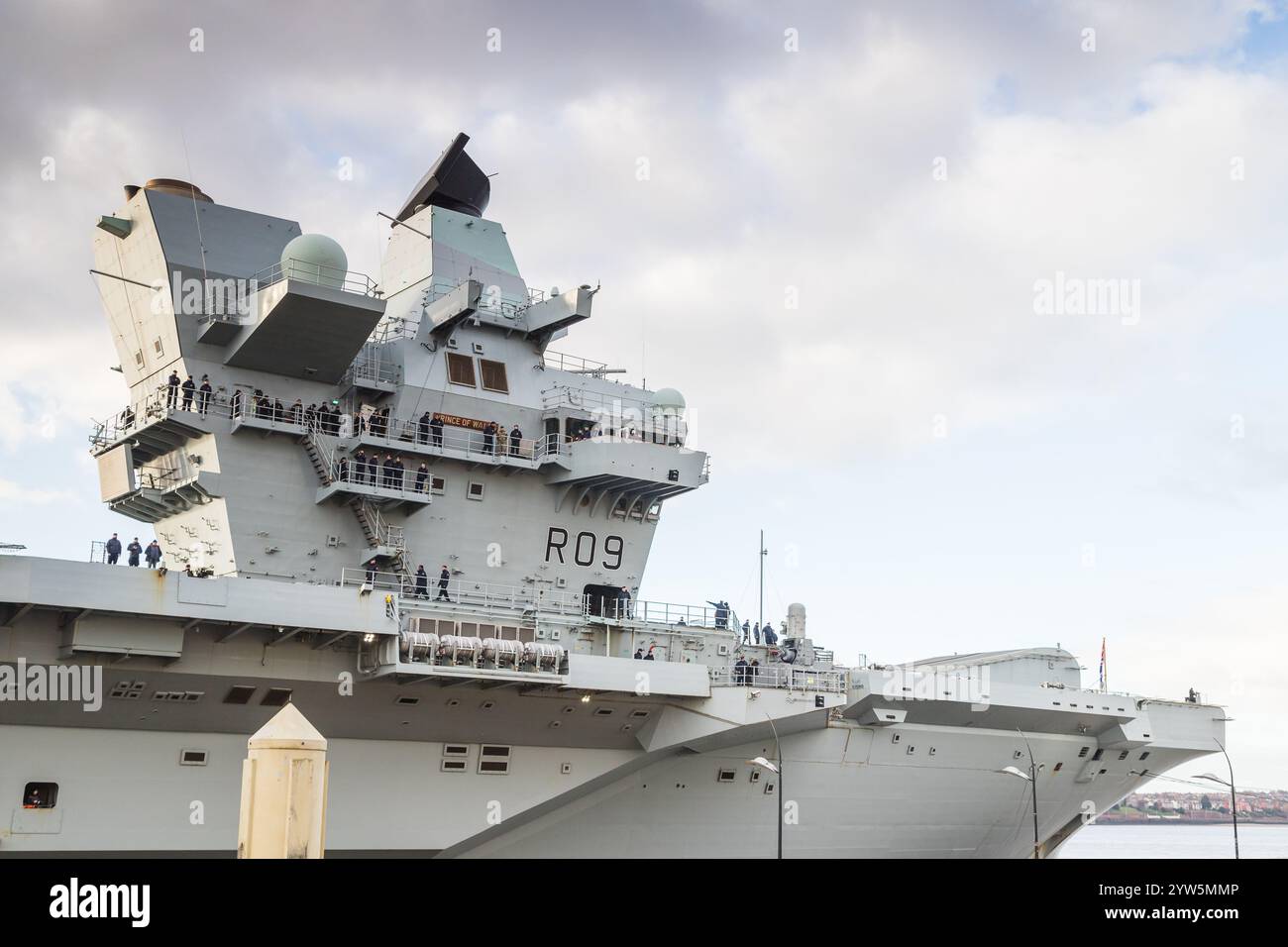 Sailors line the HMS Prince of Wales aircraft carrier as she prepares ...