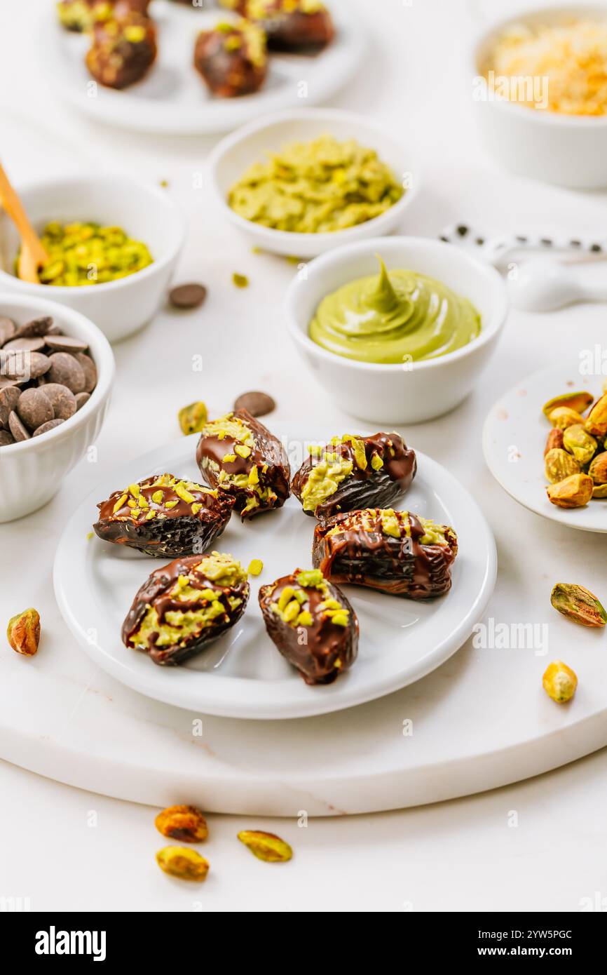 Preparing exquisite dessert, dates filled with pistachio mousse ...