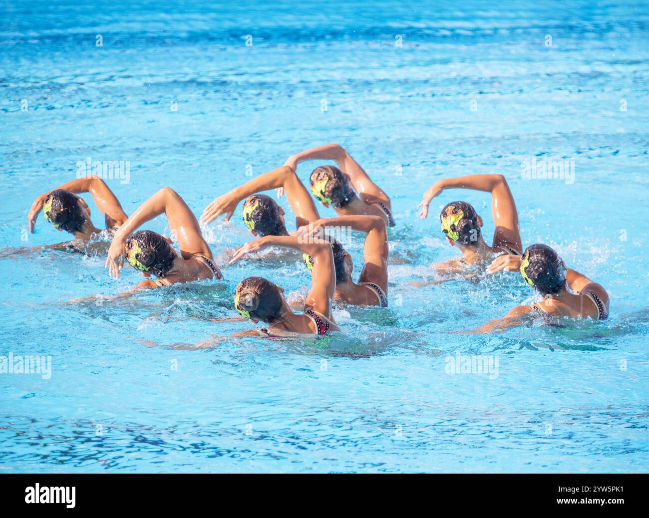 Synchronized swimmers team performing artistic swimming in the swimming pool Stock Photo - Alamy
