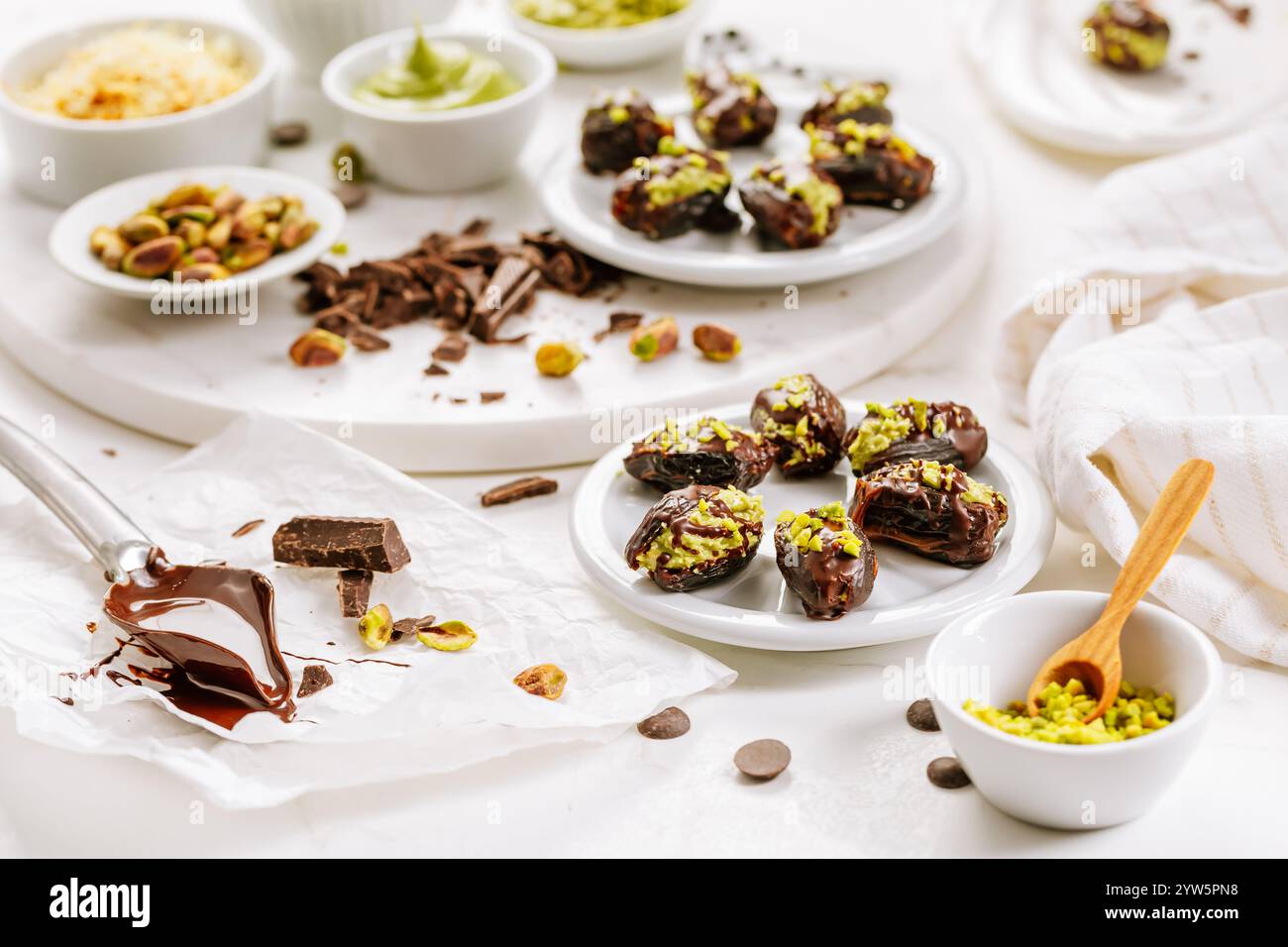 Preparing exquisite dessert, dates filled with pistachio mousse ...