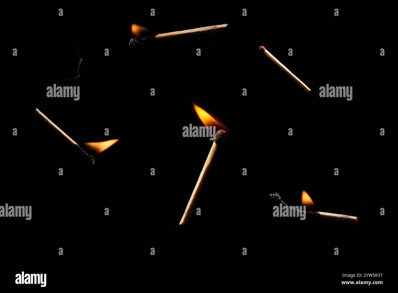Lit and falling match on a black background Stock Photo - Alamy