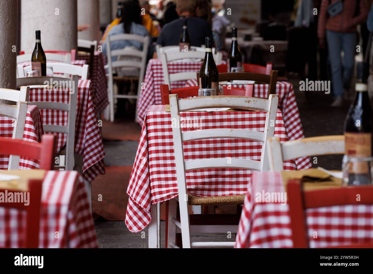 Empty tables and chairs outside a restaurant under the city's iconic ...