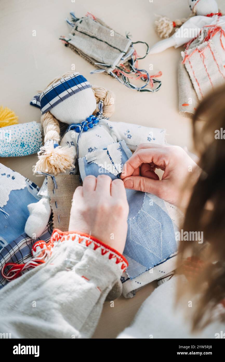 Handmaking traditional folk dolls with intricate details. Celebrating ...