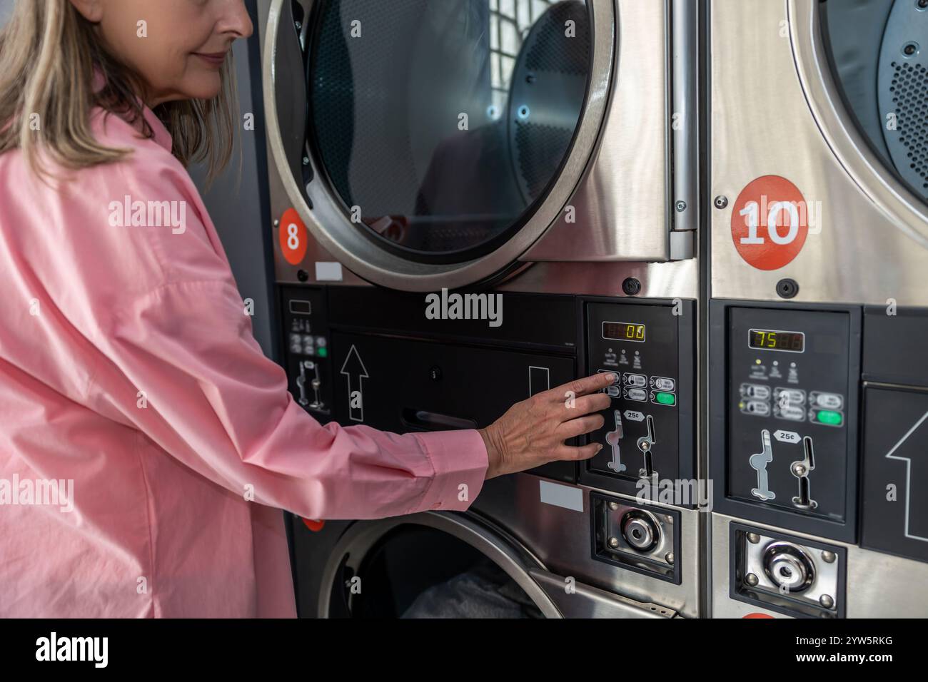 Close up picture of female hand programming washing machine Stock Photo ...