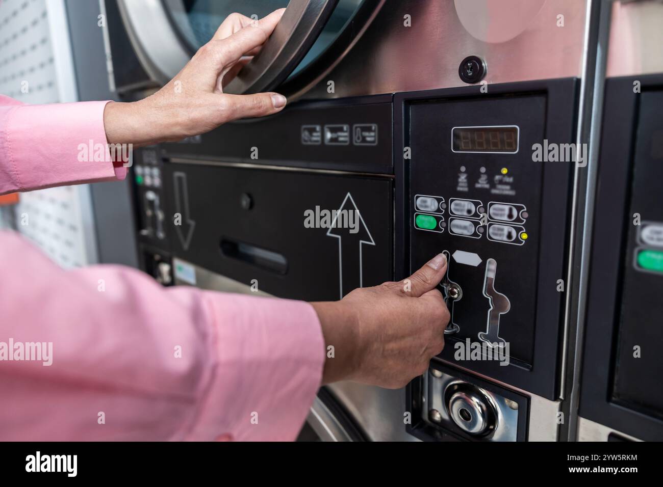 Close up picture of female hand programming washing machine Stock Photo ...