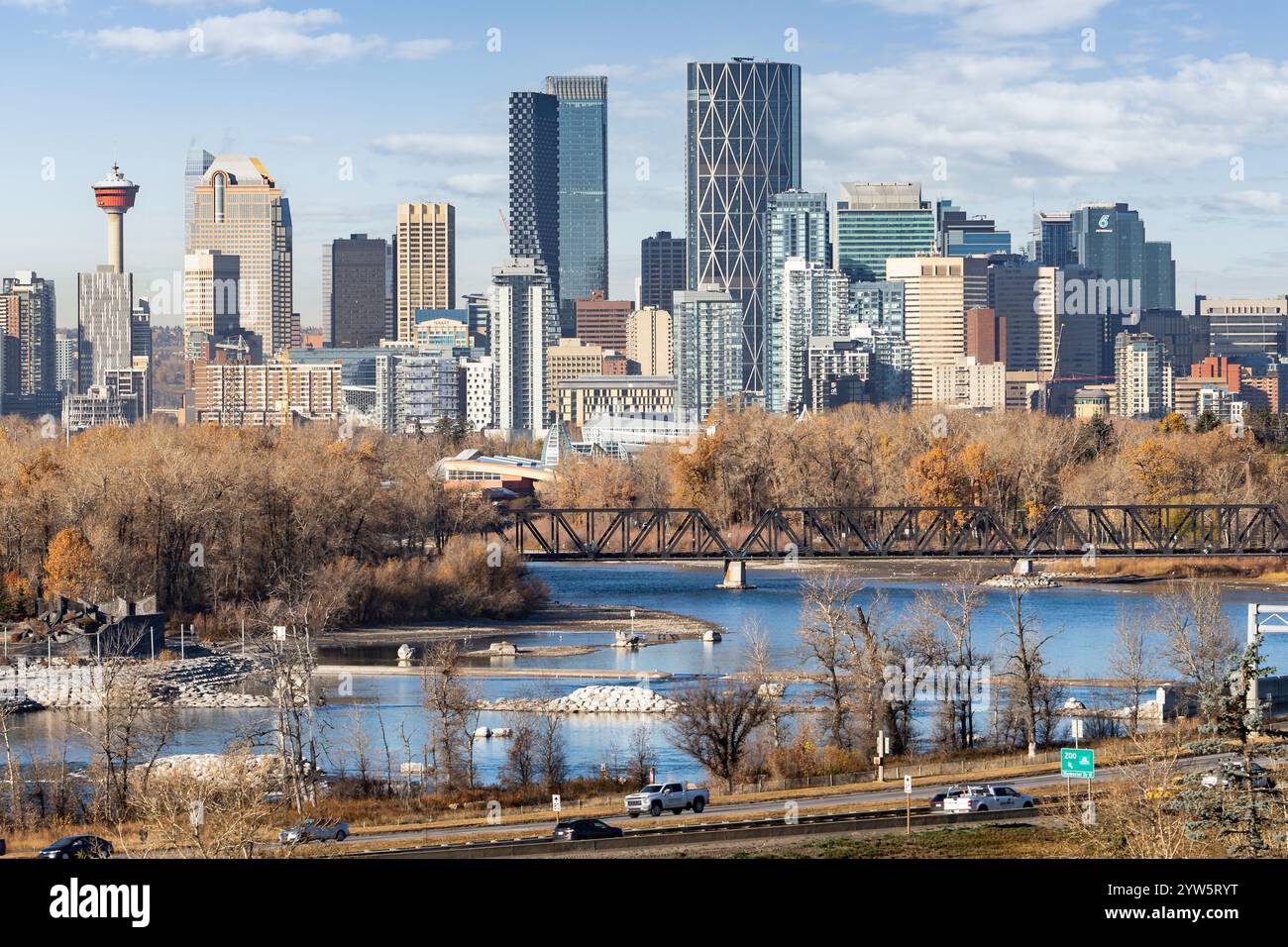 Calgary downtown skyline overlooking the Bow river and train bridge with popular tourist ...