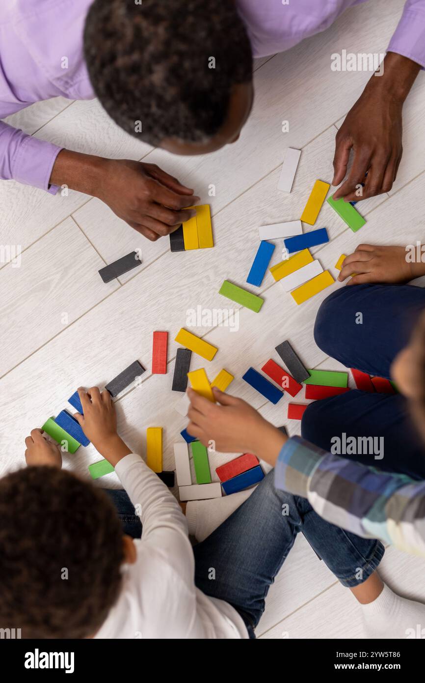 Kids and their dad playing jenga on the floor Stock Photo - Alamy