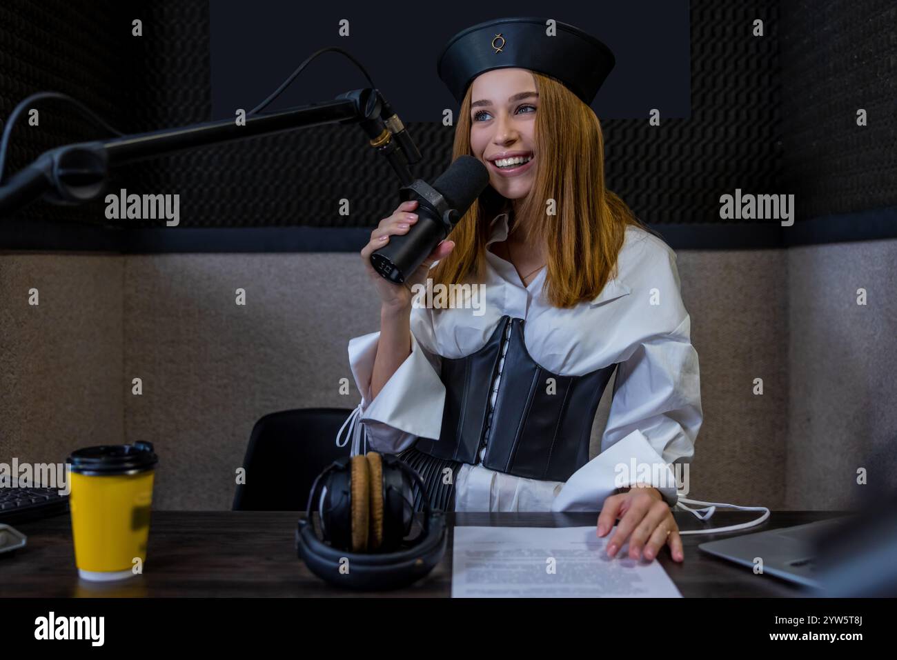 Female radio host broadcasting through microphone in studio Stock Photo ...