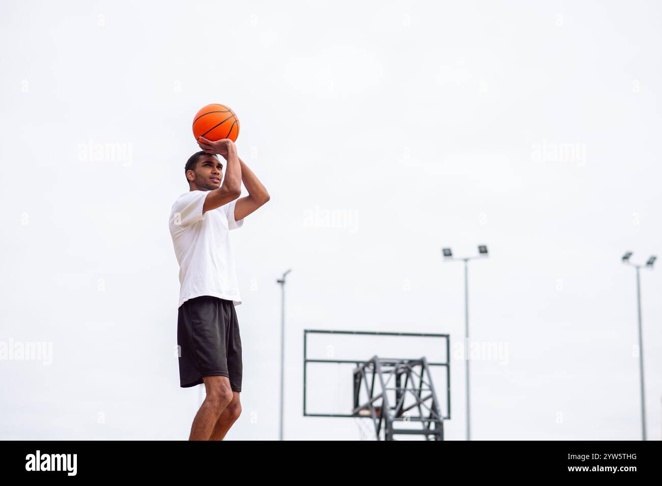 Basketball player getting ready for throwing the ball to the basket ...