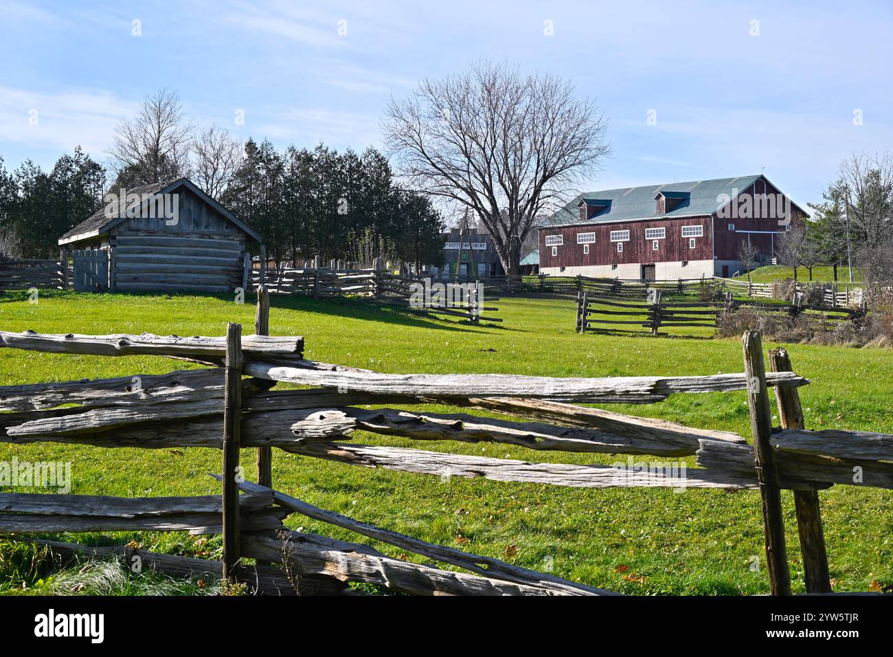 A barn houses in the agriculture field with the fences in foreground ...
