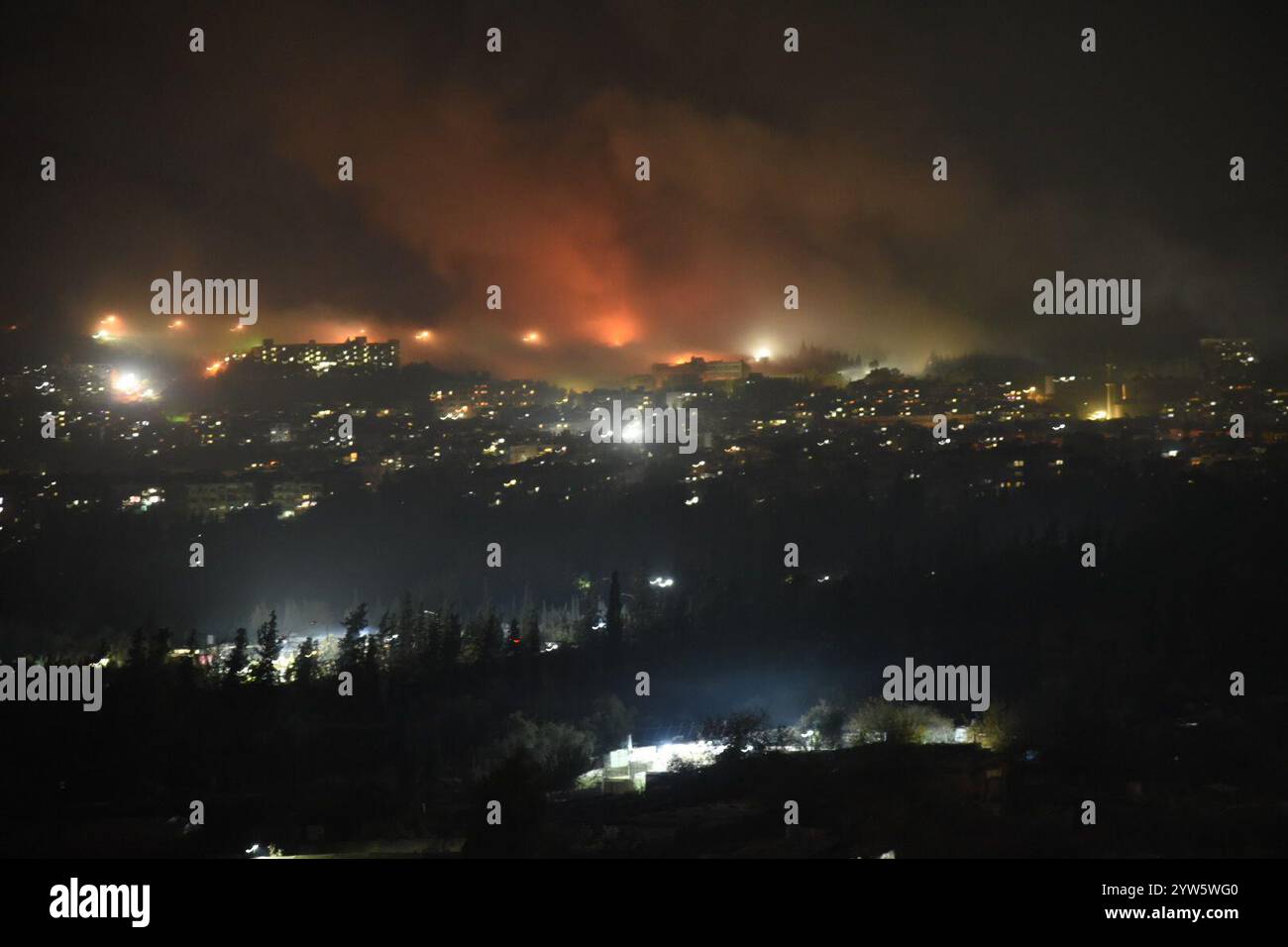 Damascus, Syria. 9th Dec, 2024. Smoke rises following airstrikes in ...