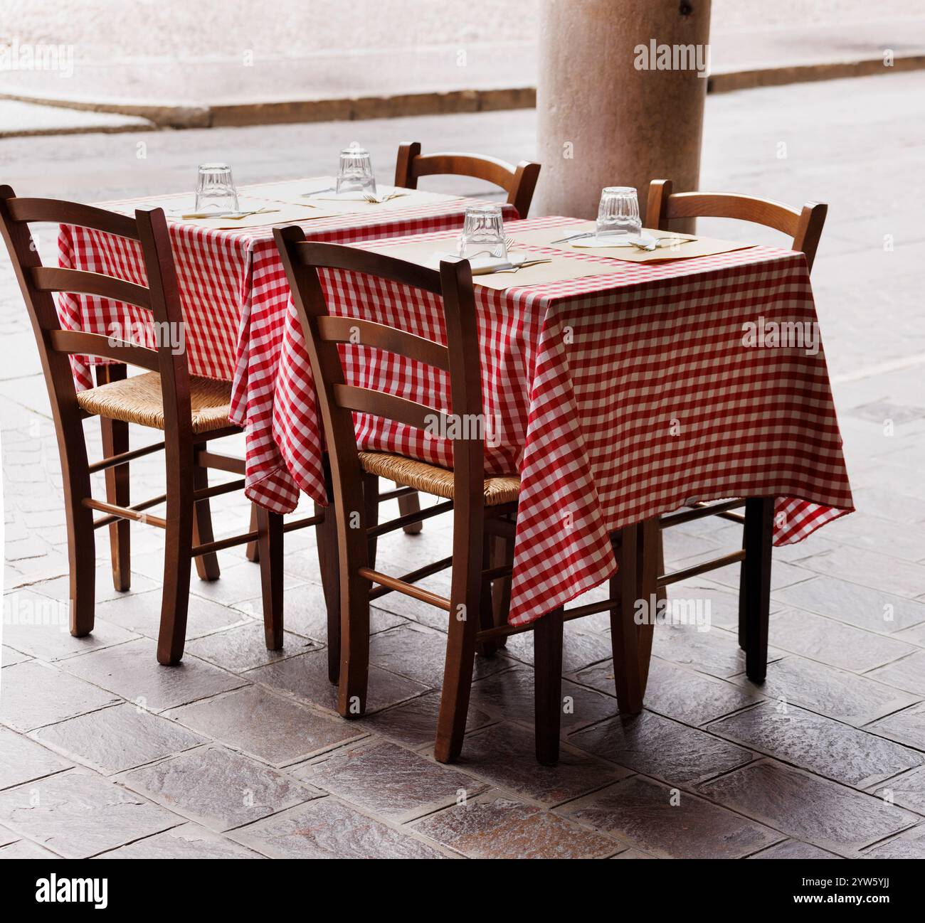 Empty tables and chairs outside a restaurant under the city's iconic ...