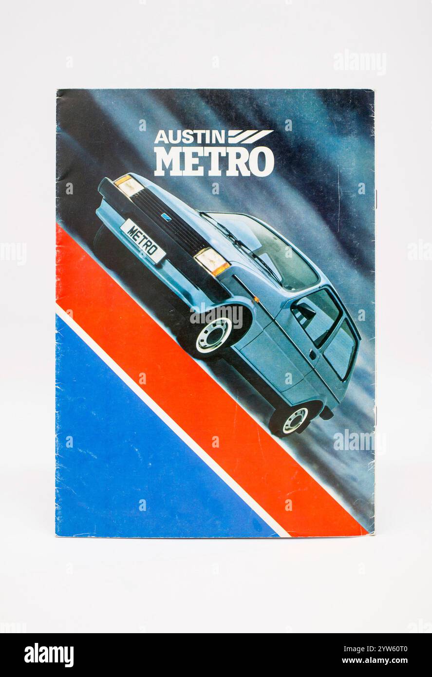 Vintage Austin Metro car brochure cover featuring a blue model on a dynamic red and blue ...