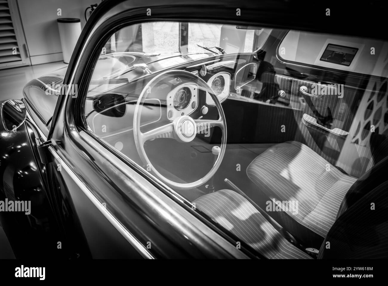 the view through the side window of a vintage VW Beetle into the ...