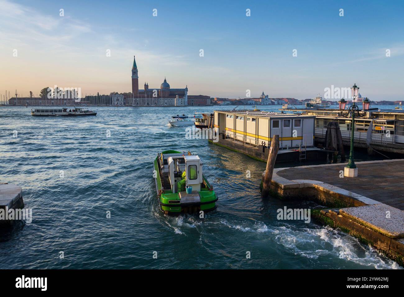 Green garbage collector boat transporting waste on October 29, 2022 in ...
