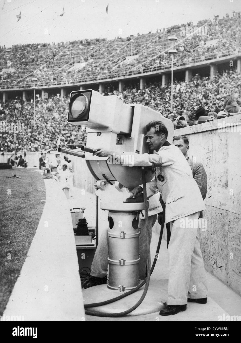 A Paul Nipkow television cameraman films a sports event in the Olympic ...