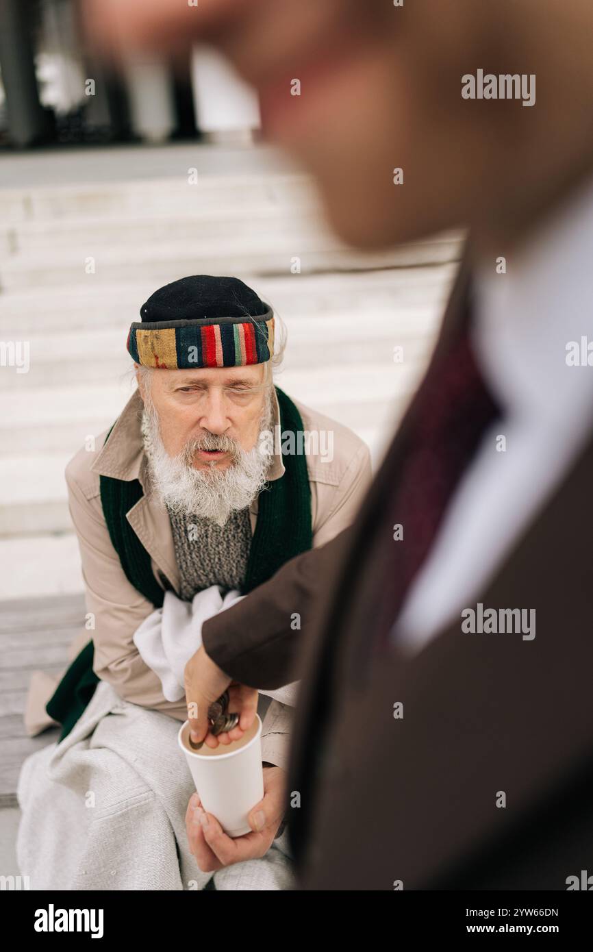 Vertical shot of contrast between wealth and poverty as businessman ...