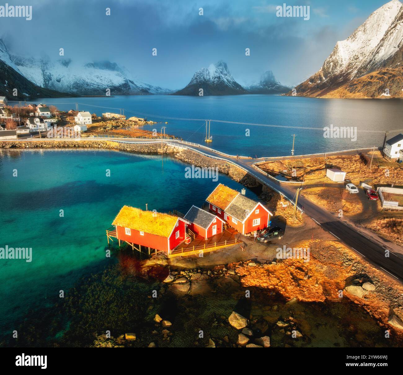 Aerial view of red rorbu houses, blue sea and snowy mountains Stock ...