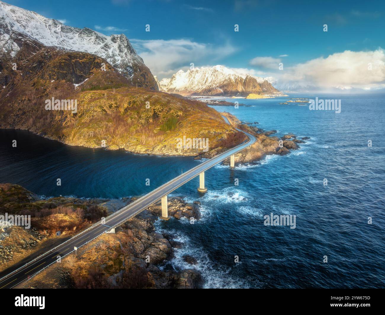 Aerial view of bridge crossing the fjord with snowy mountains Stock ...