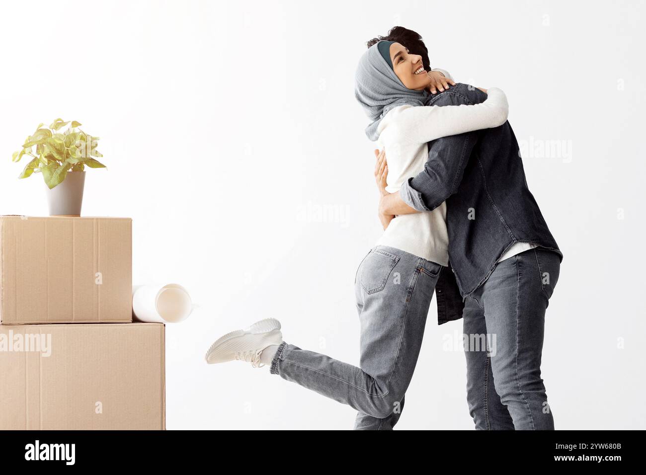Emotional muslim lady hugging her husband, moving in Stock Photo - Alamy