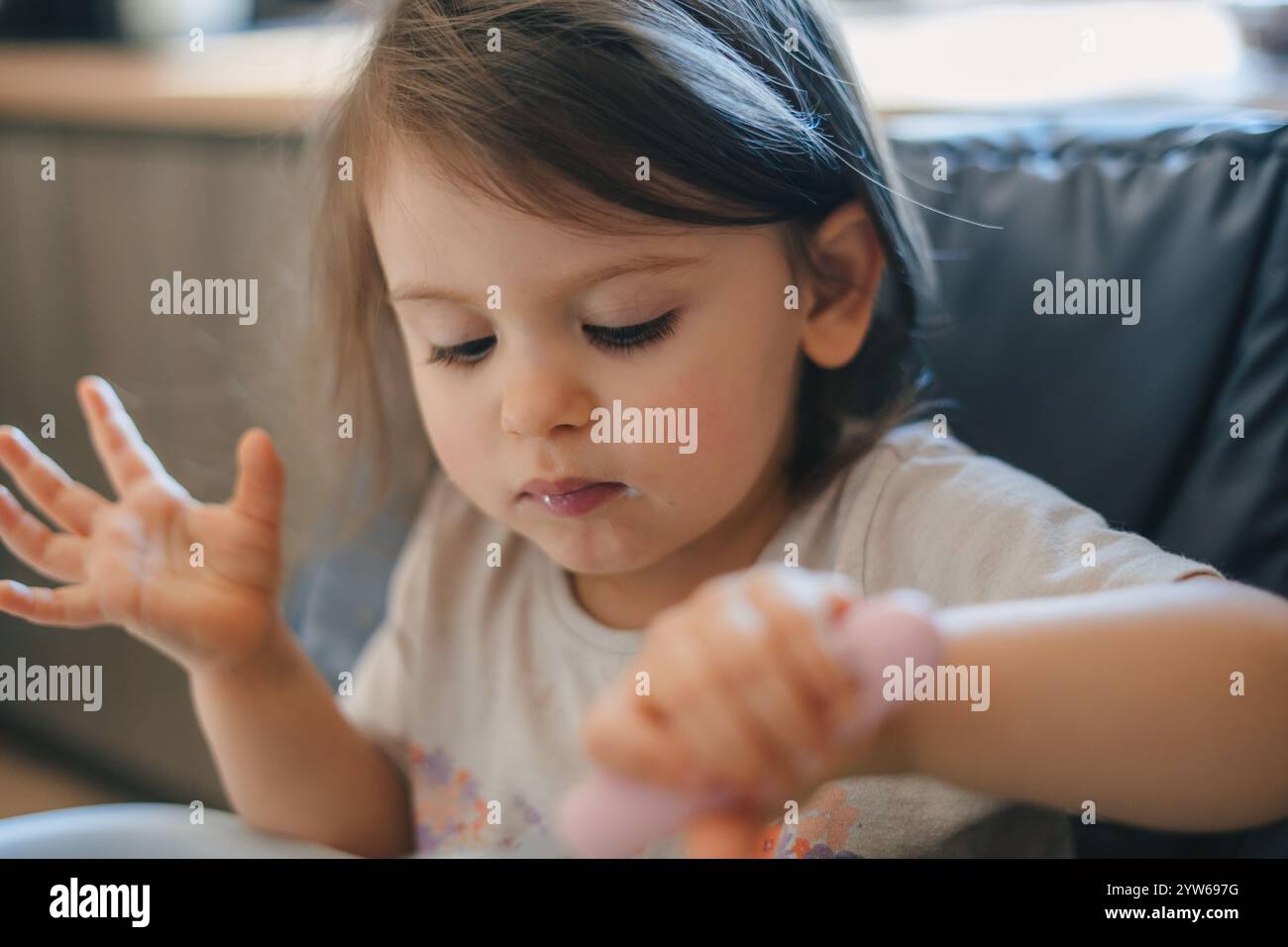 A child is fully enjoying an engaging activity with a focused and ...